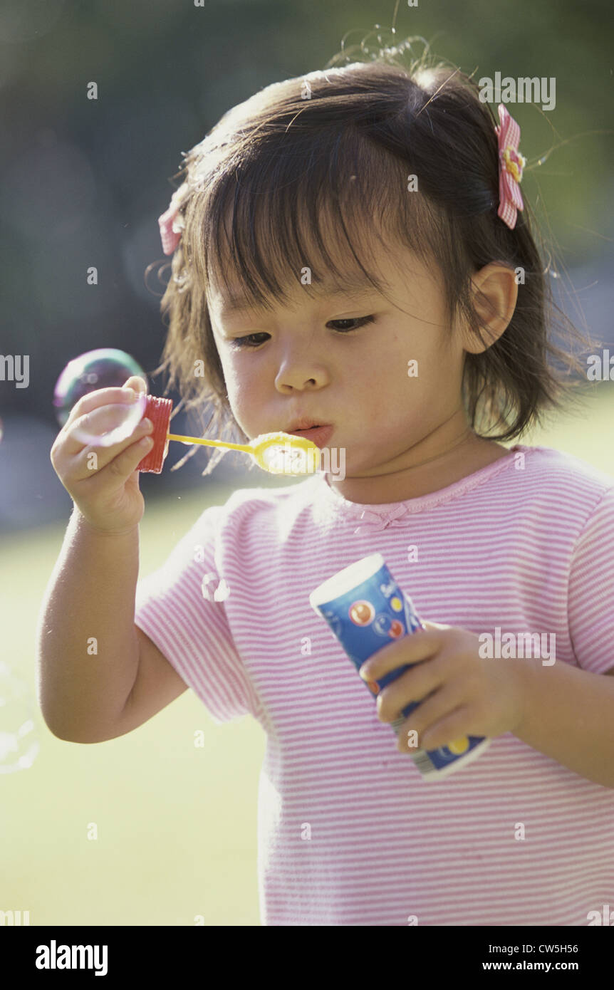 Girl blowing bubbles with a bubble wand hi-res stock photography and images - Alamy