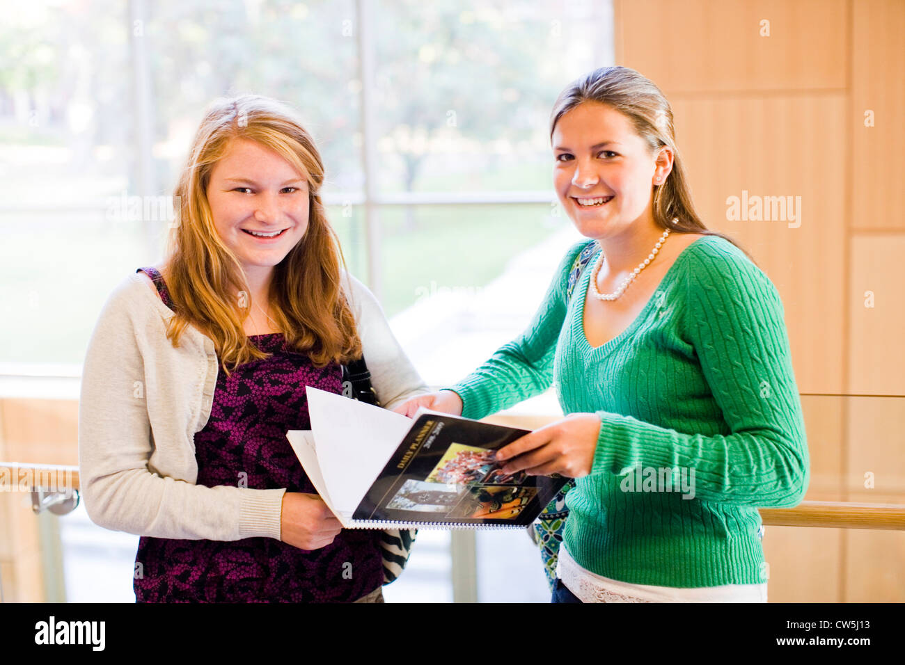 Two students reading a book Stock Photo - Alamy