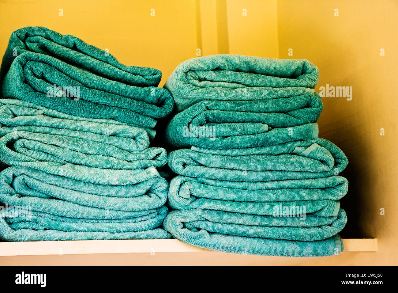 Stack of towels on a rack Stock Photo - Alamy