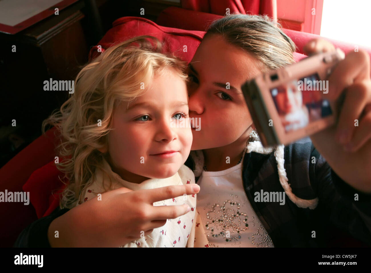 Two girls taking a picture of their self Stock Photo - Alamy