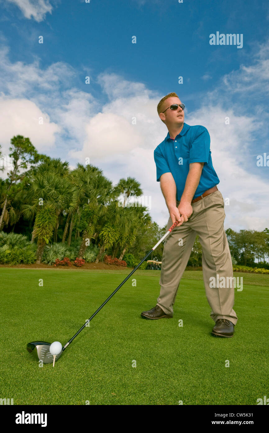 Golfer teeing off Stock Photo - Alamy