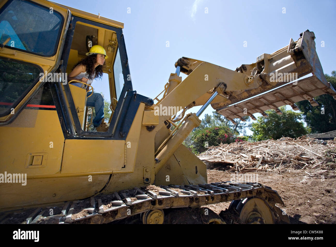 Female construction worker operating a bulldozer at a construction site ...