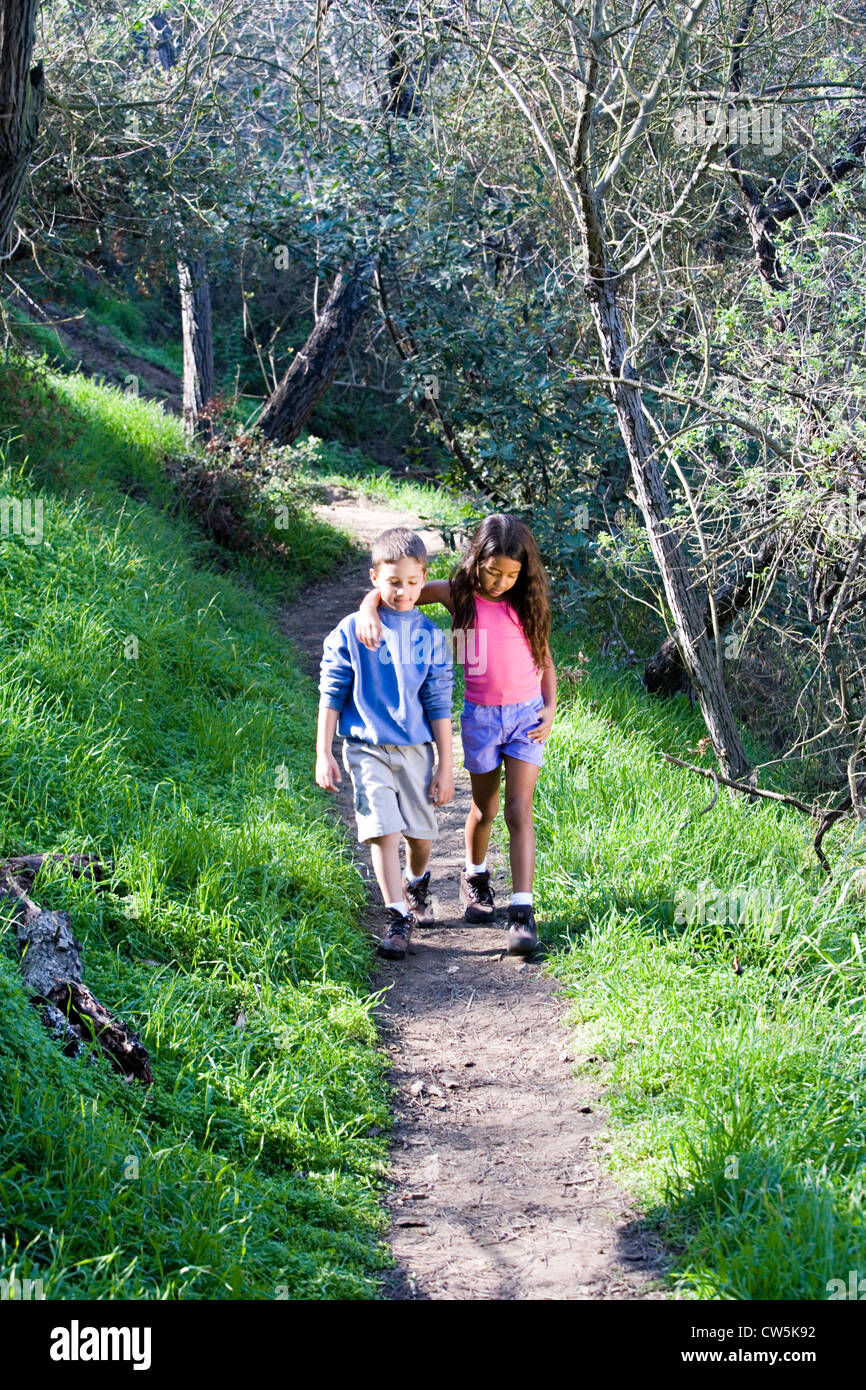 Boy and girl walking on a trail Stock Photo - Alamy