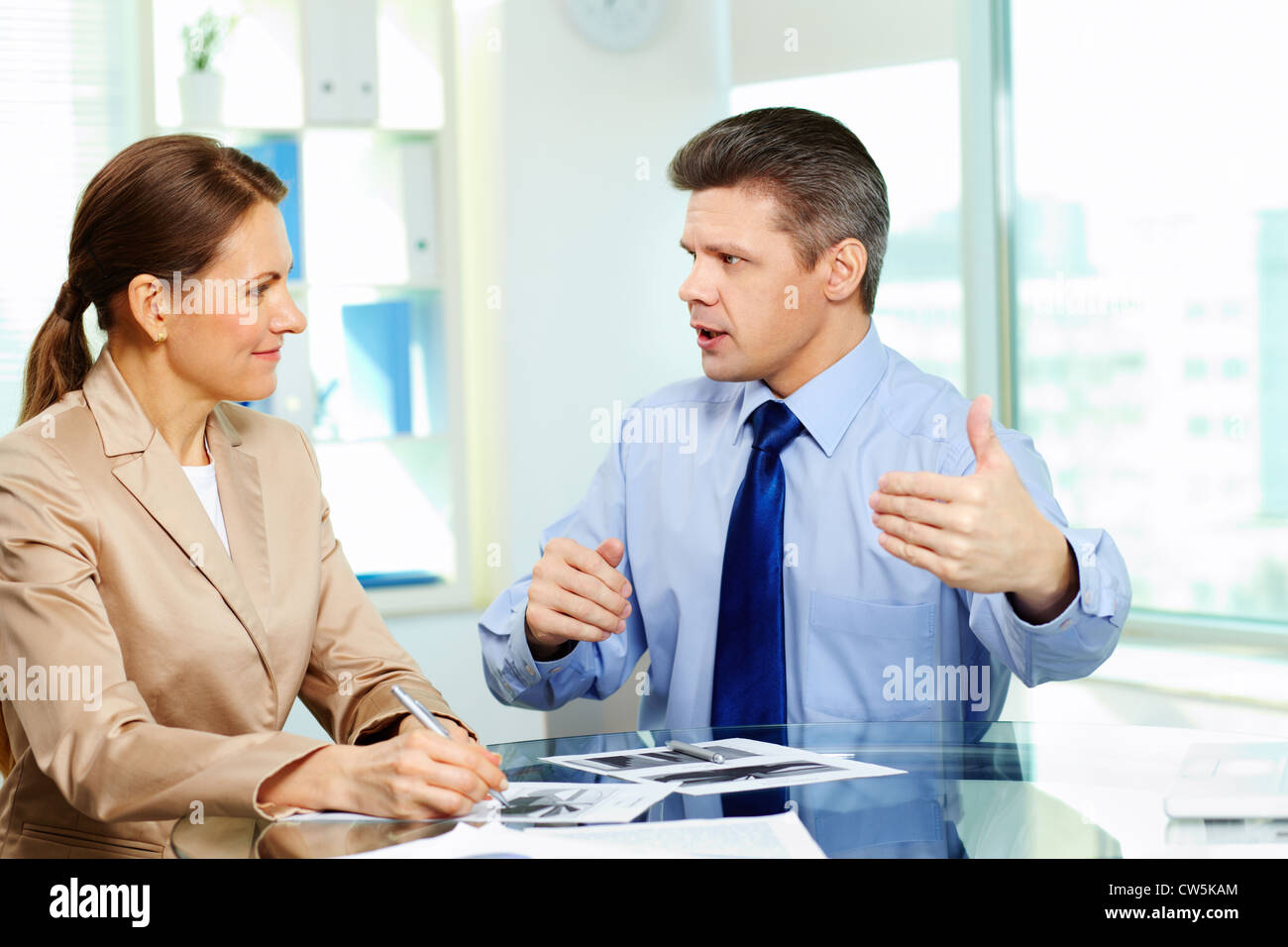 Team members discussing business plan and ideas in office Stock Photo ...