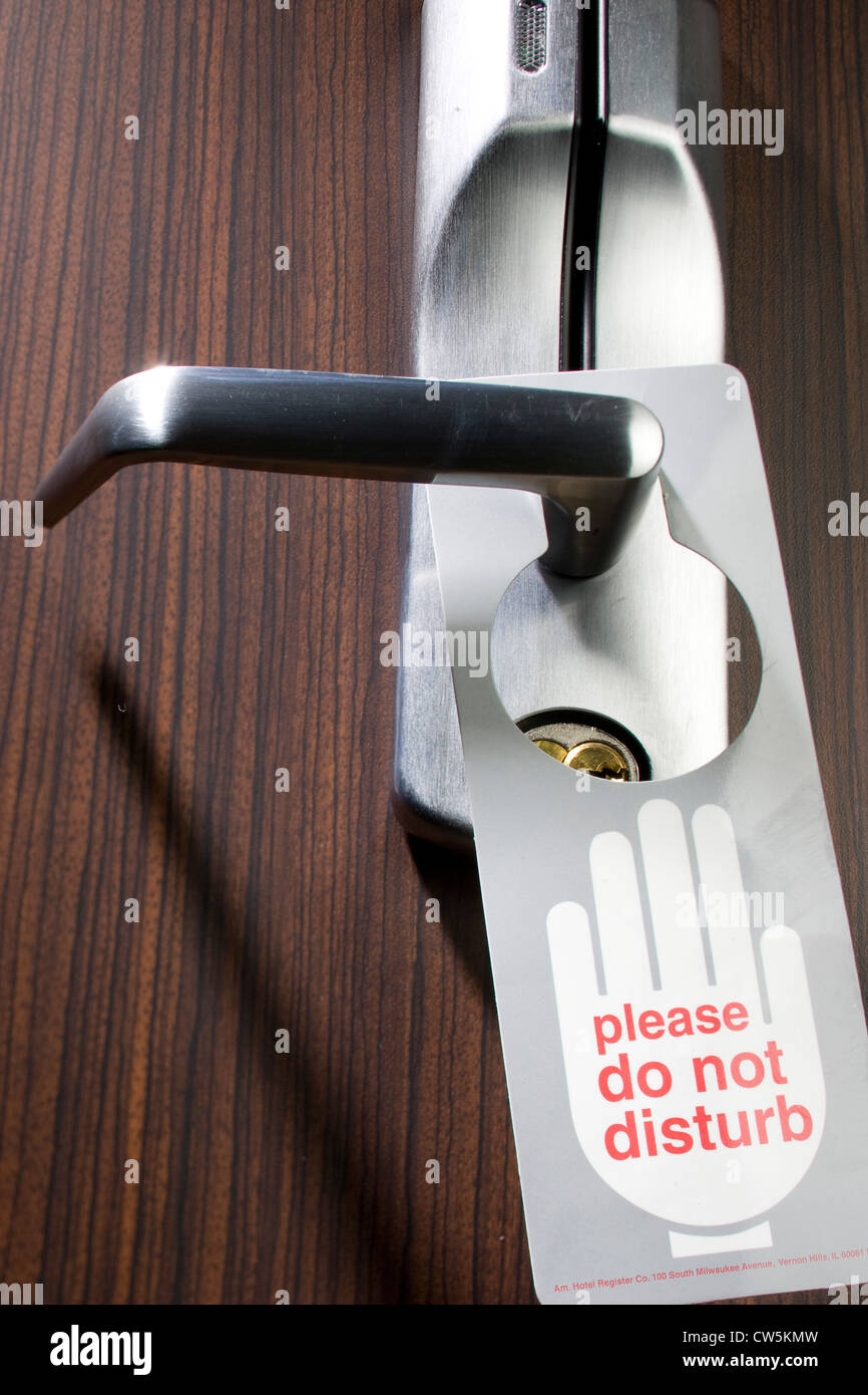 Do Not Disturb sign hanging from hotel door handle Stock Photo - Alamy