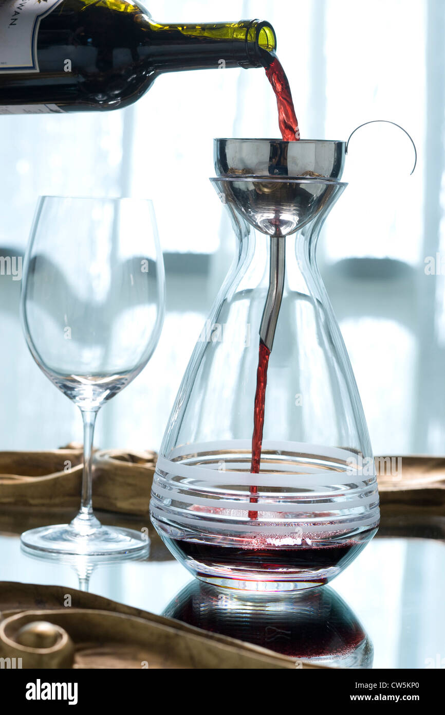 Red wine being poured into a decanter Stock Photo - Alamy