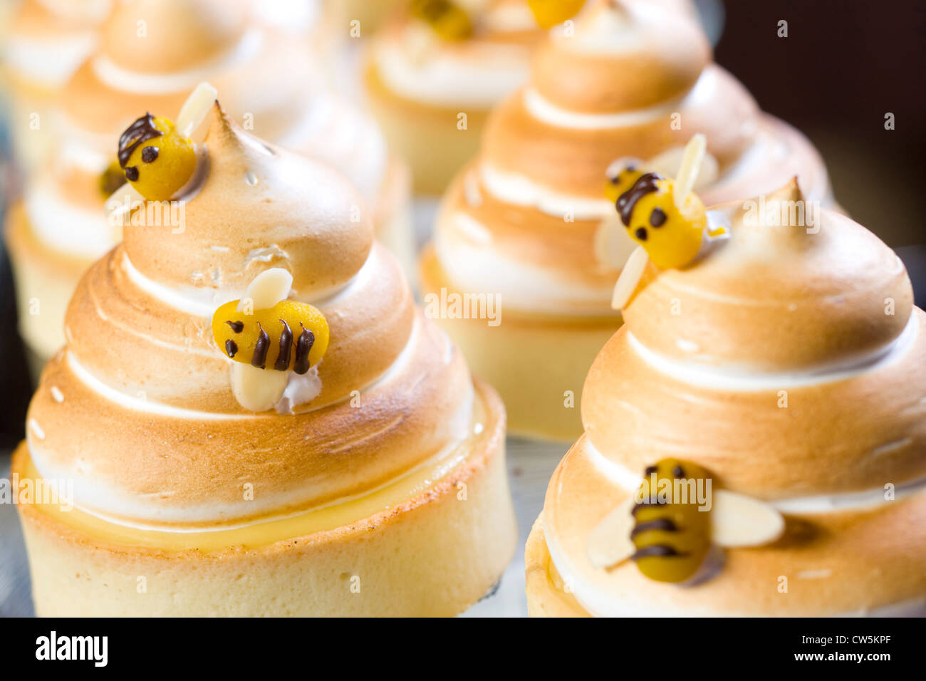Lemon meringue tarts with marzipan bees Stock Photo - Alamy