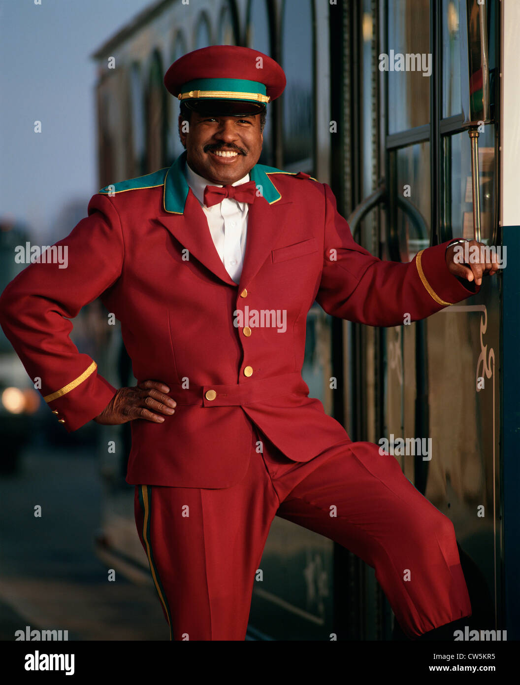 Portrait of a male driver standing next to a trolley Stock Photo - Alamy