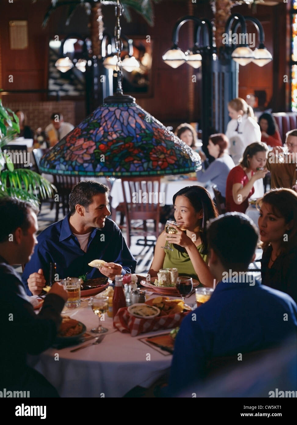Food and drink sitting crowded eating table chair hi-res stock ...