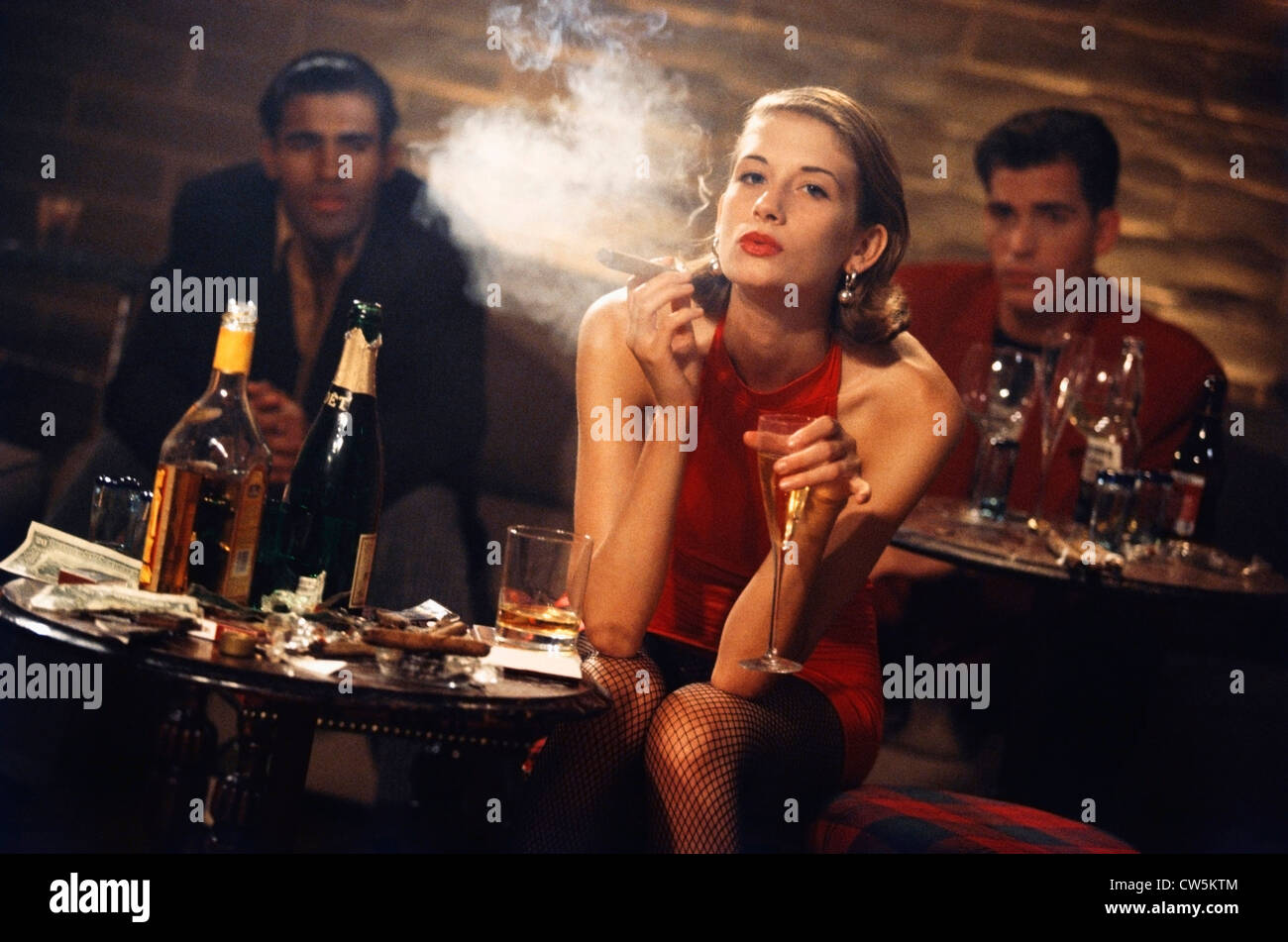 Young woman smoking a cigar in a bar Stock Photo - Alamy