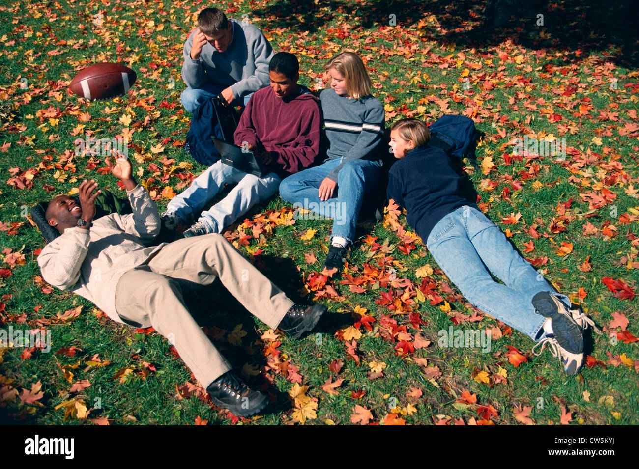 University students lying on grass and fallen leaves Stock Photo - Alamy