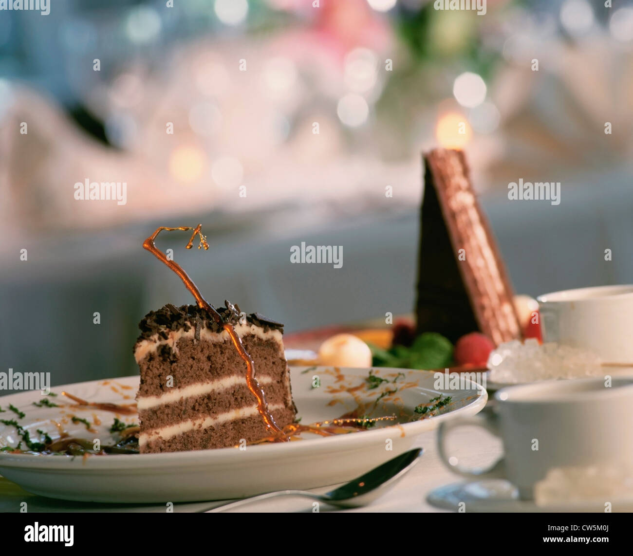 Chocolate cake and coffee cups on a table Stock Photo - Alamy