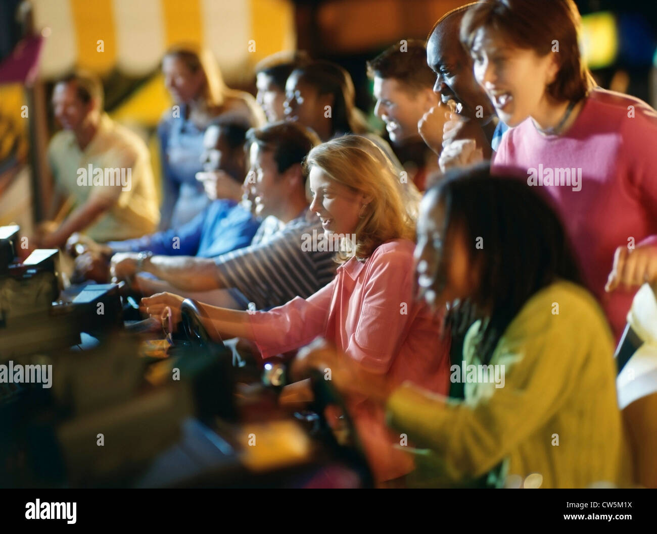 People playing video games in an amusement arcade Stock Photo - Alamy