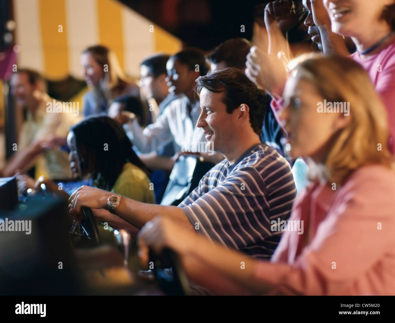 People playing video games in an amusement arcade Stock Photo - Alamy