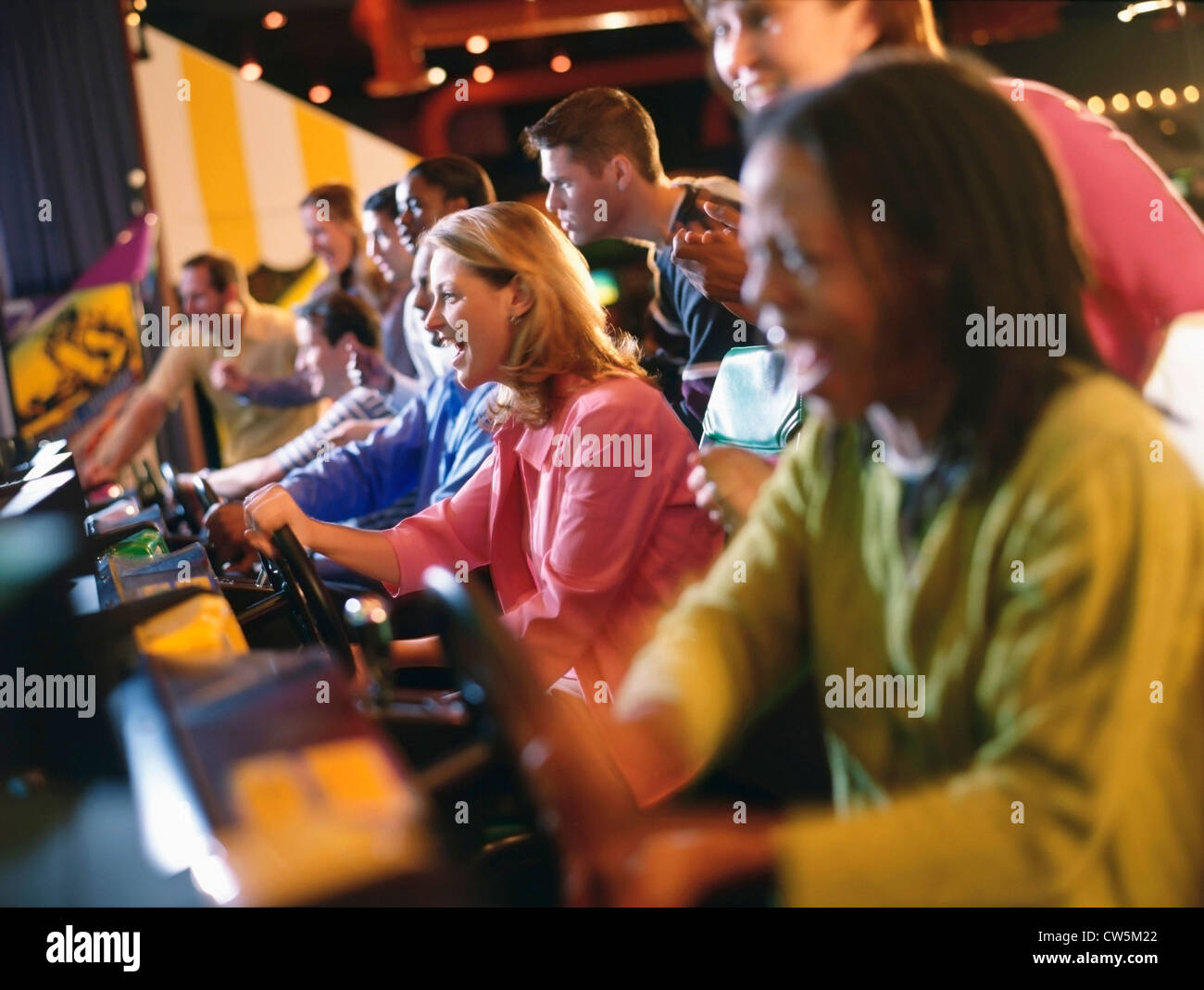 People playing video games in an amusement arcade Stock Photo - Alamy