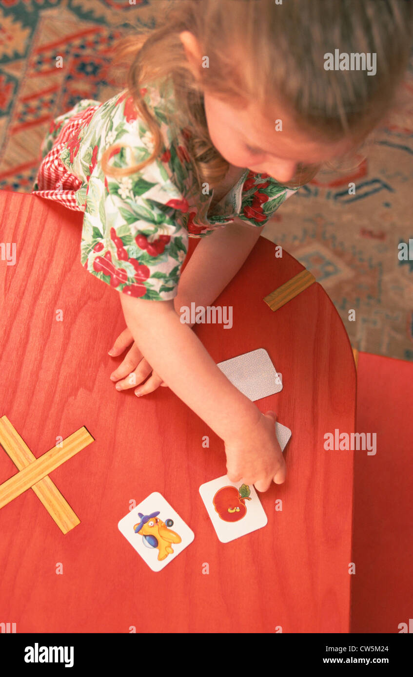 Girl playing cards game on a table Stock Photo - Alamy