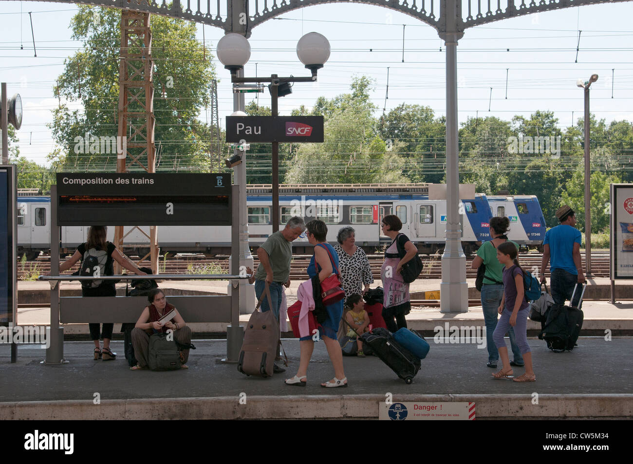 Passengers waiting on a railway station platform Gare de Pau southwest ...
