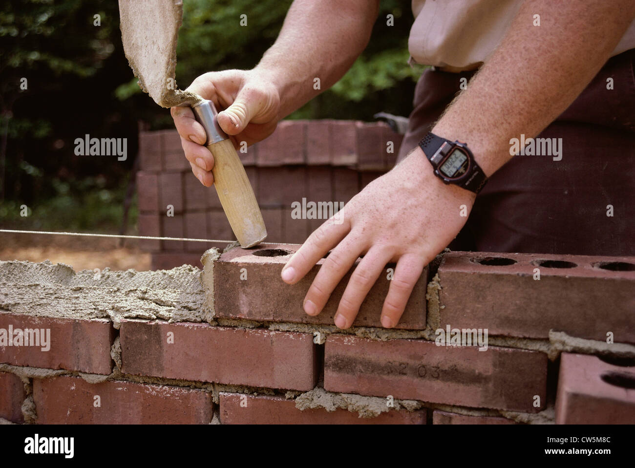 Bricklayer holding brick trowel hi-res stock photography and images - Alamy