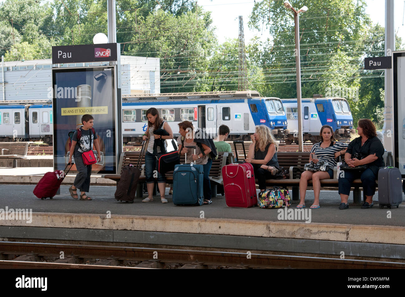 Passengers waiting on a railway station platform Gare de Pau southwest ...