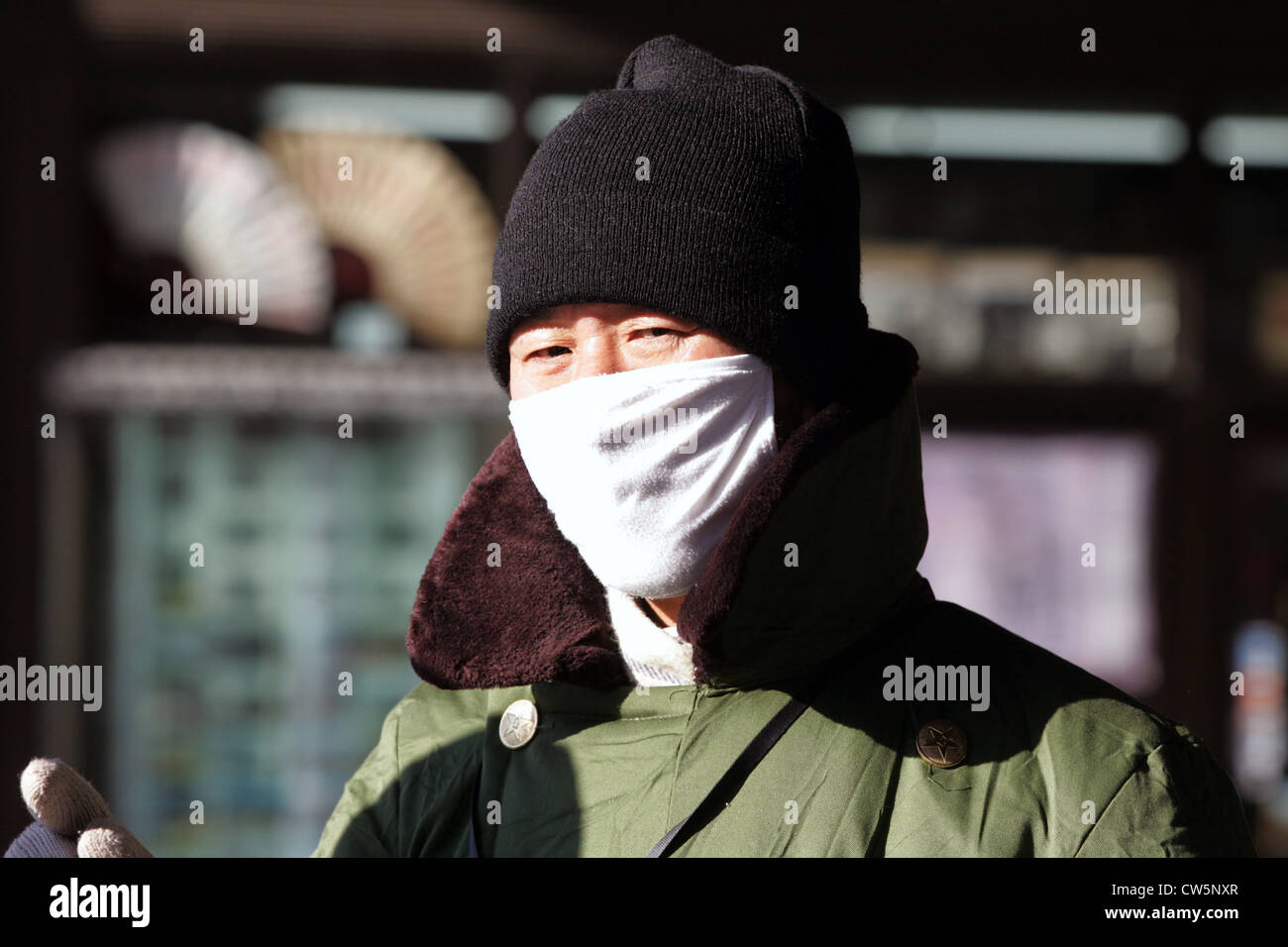 Beijing man with surgical mask on a street Stock Photo - Alamy