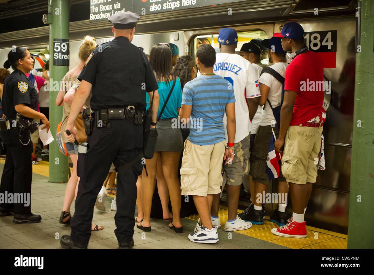 Revelers crowd the Number One subway traveling up to Washington Heights ...