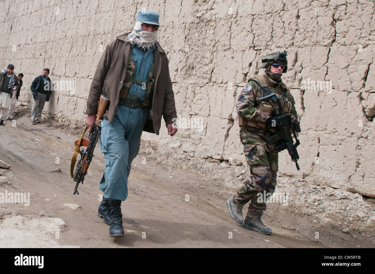 An Afghan policeman and French military policeman from joint forces ...