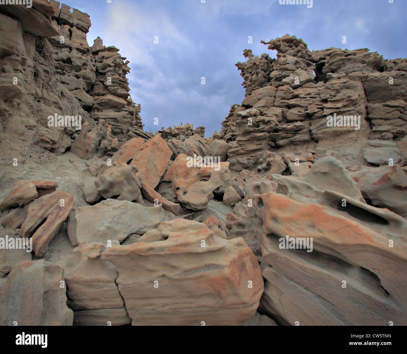 Looking up boulder strewn valley with fantastically shaped formations ...