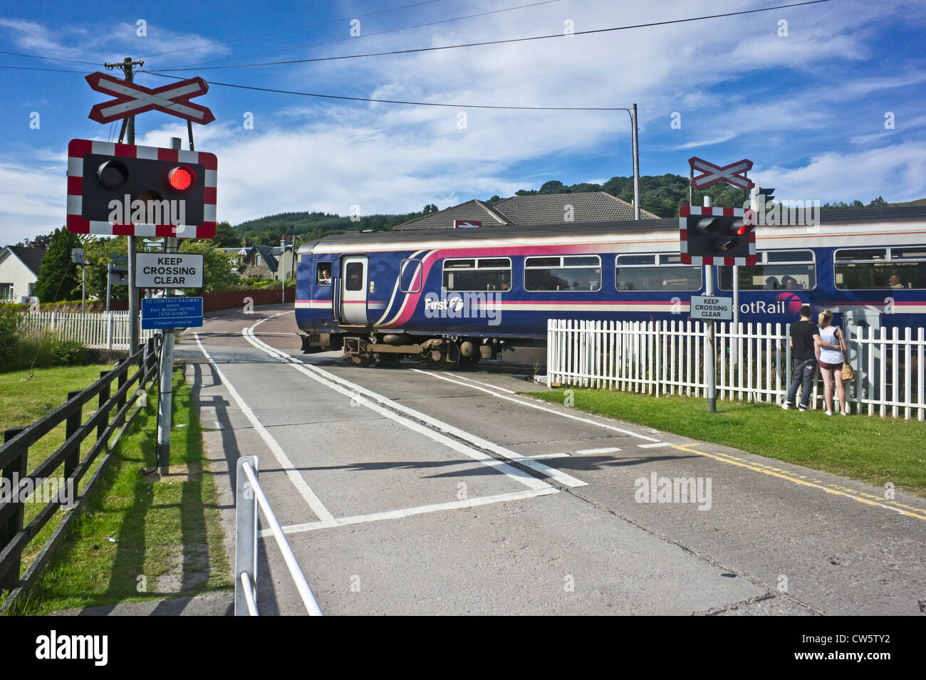 Class 156 First Scotrail DMU crossing the level crossing at the access ...