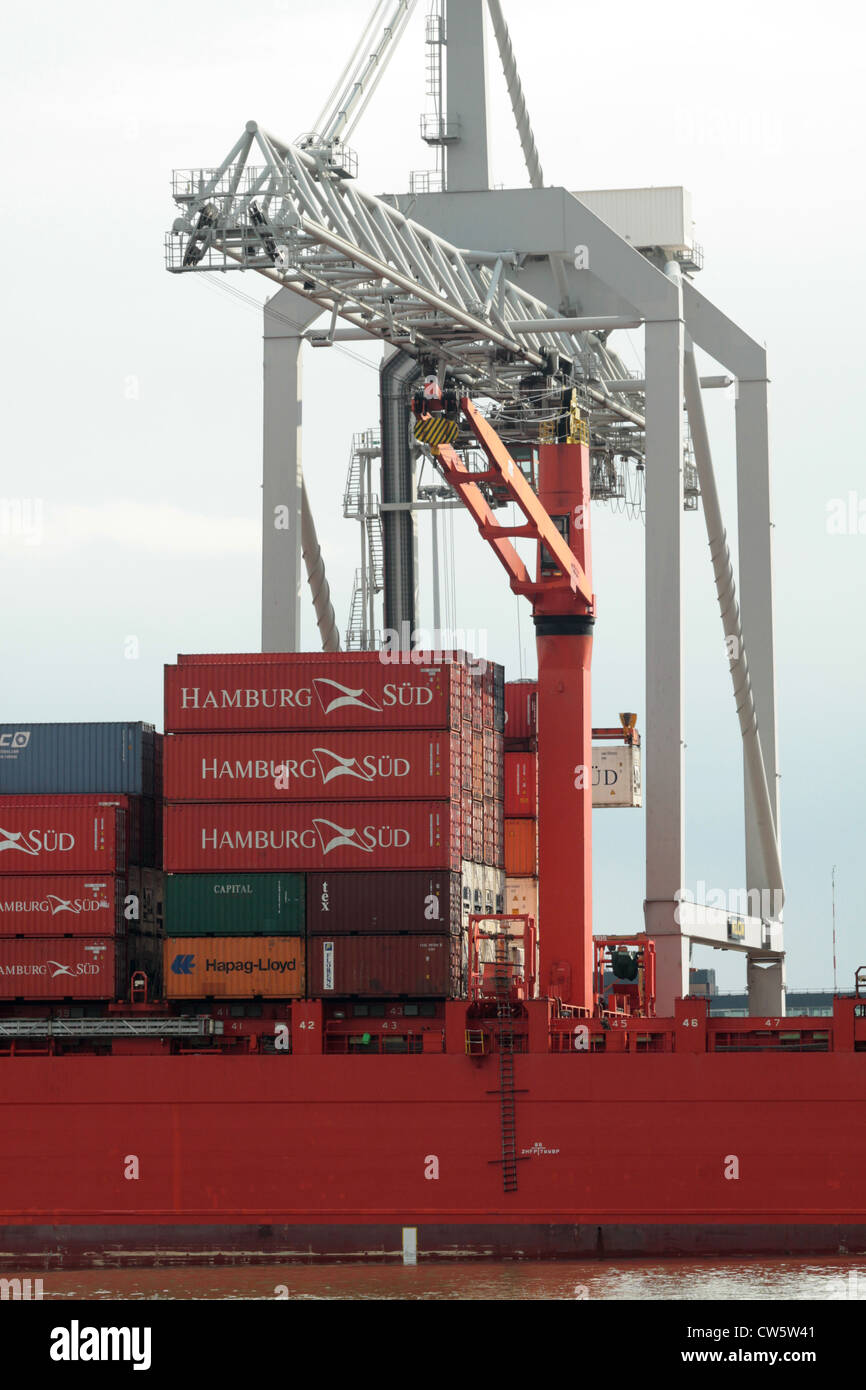 Containers on a ship being unloaded Stock Photo - Alamy