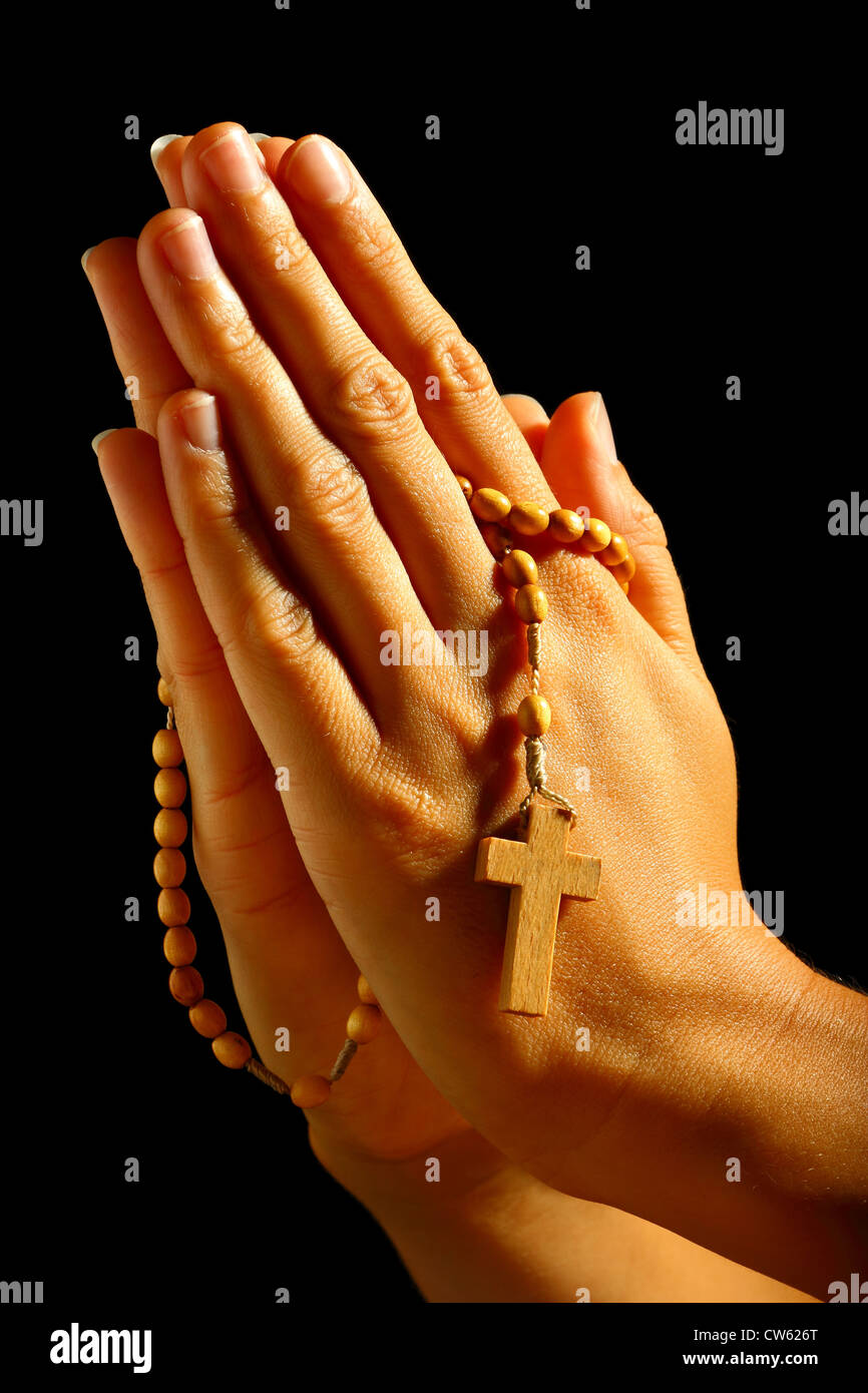 Christian human praying with rosary in hands Stock Photo - Alamy