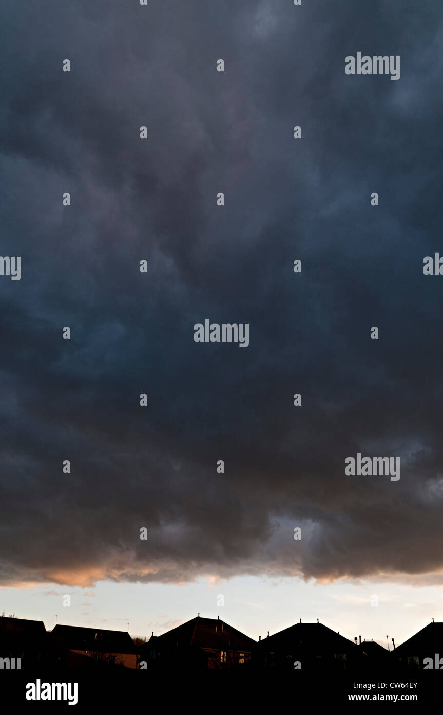 dark clouds coming in with a storm front over houses Stock Photo - Alamy