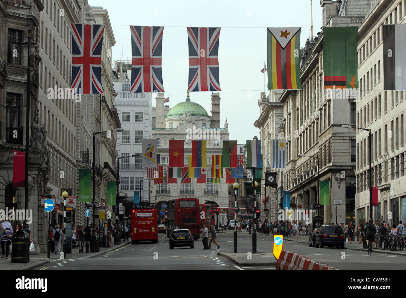 London Red double decker buses and taxis in Waterloo Place London, with ...