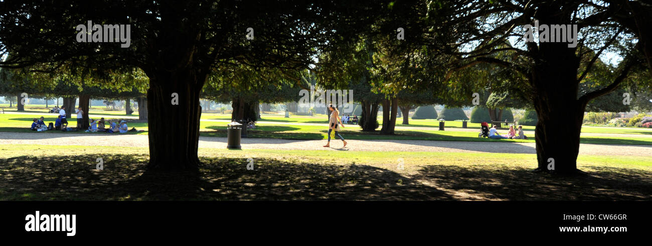 Panoramic widescreen shot of people walking through gardens at hampton ...