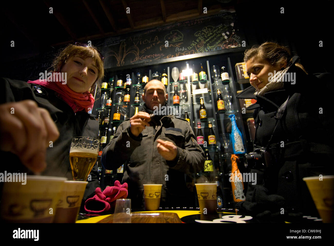 three people drinking beer in largest beer store of Belgium, Belgium ...
