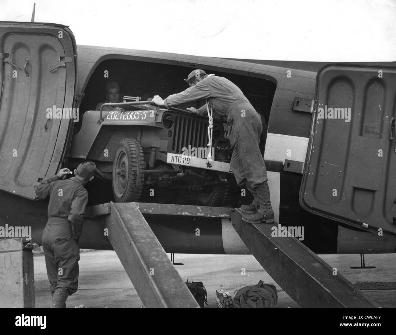 A Jeep comes out of a C-47 Skymaster. Orly Airport July 2, 1945 Stock ...