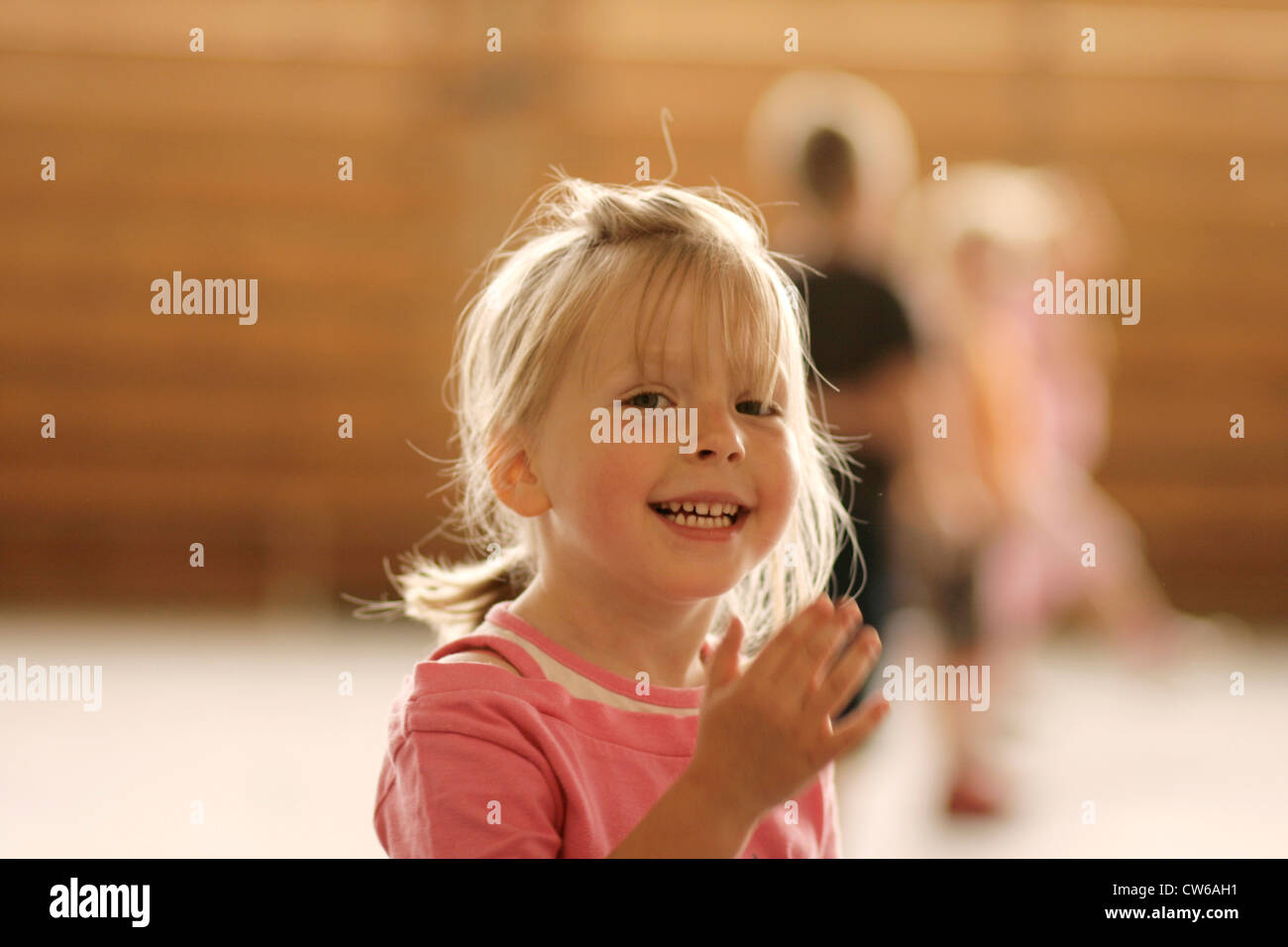 small girl running in sports hall Stock Photo - Alamy