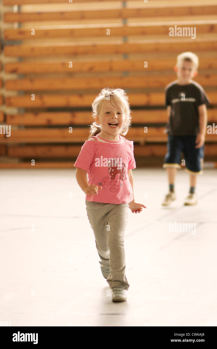 small girl running in a sports hall Stock Photo - Alamy
