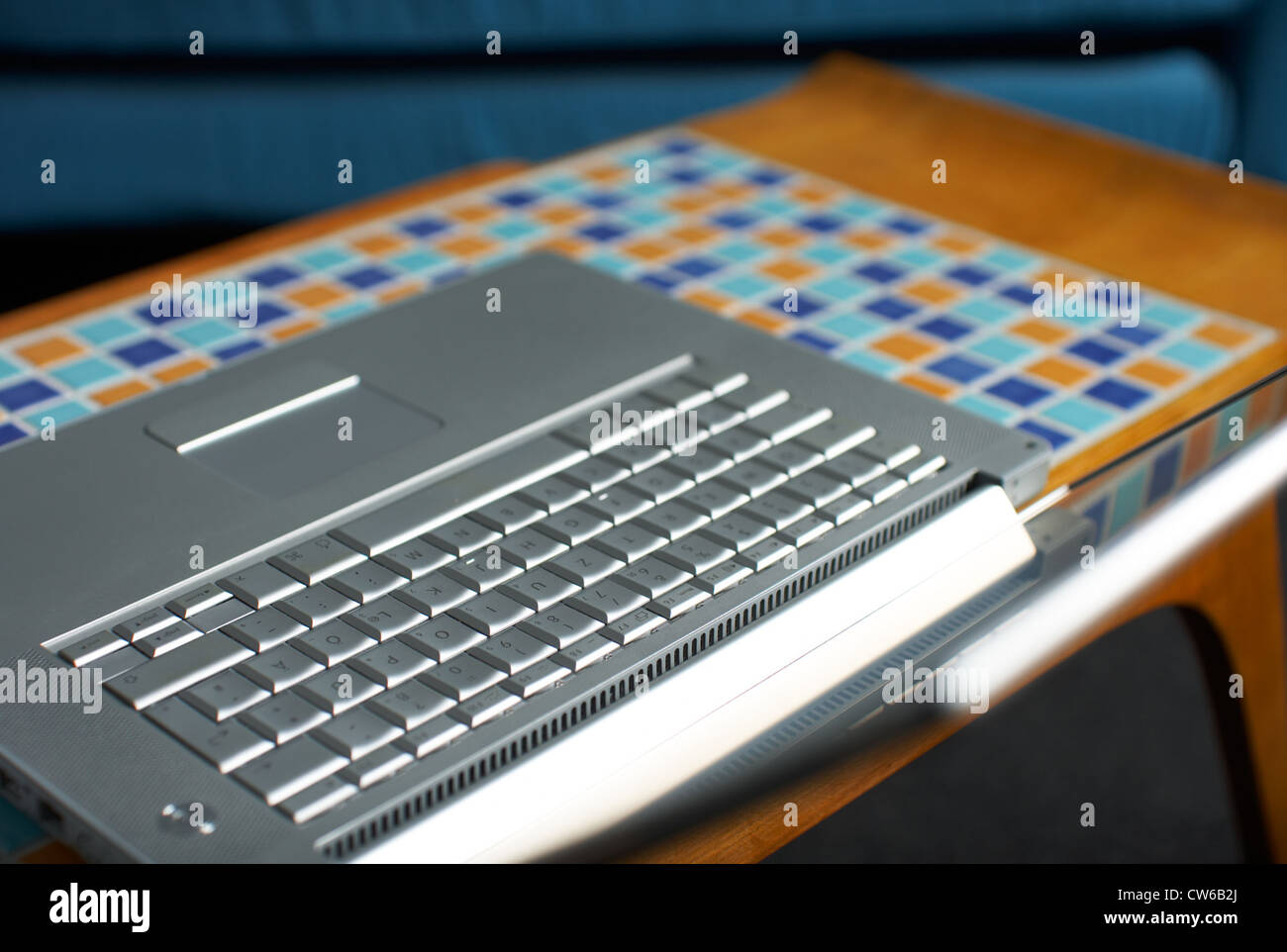 An opened laptop on a side table Stock Photo - Alamy