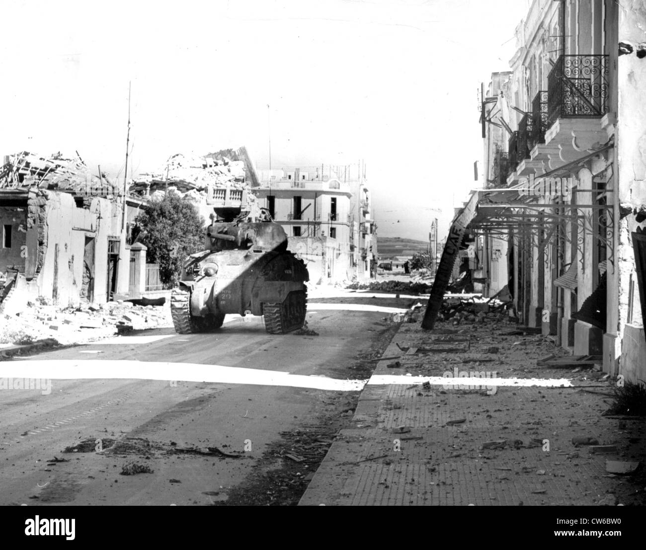 A U.S heavy tank rolls down a wrecked street of Ferryville, Tunisia ...
