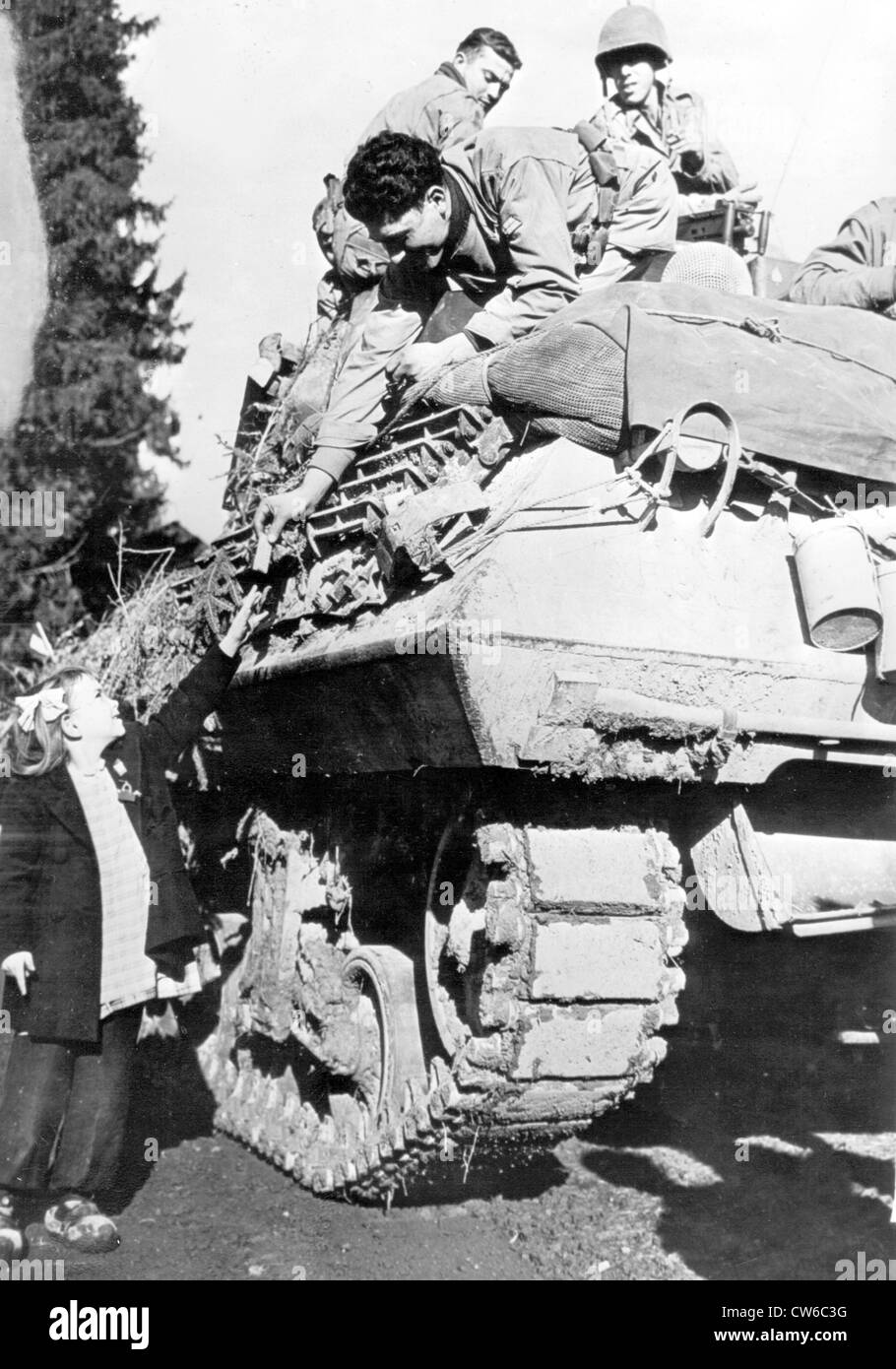 A 1st French Army tank crew gives a chocolate bar to a French girl in ...