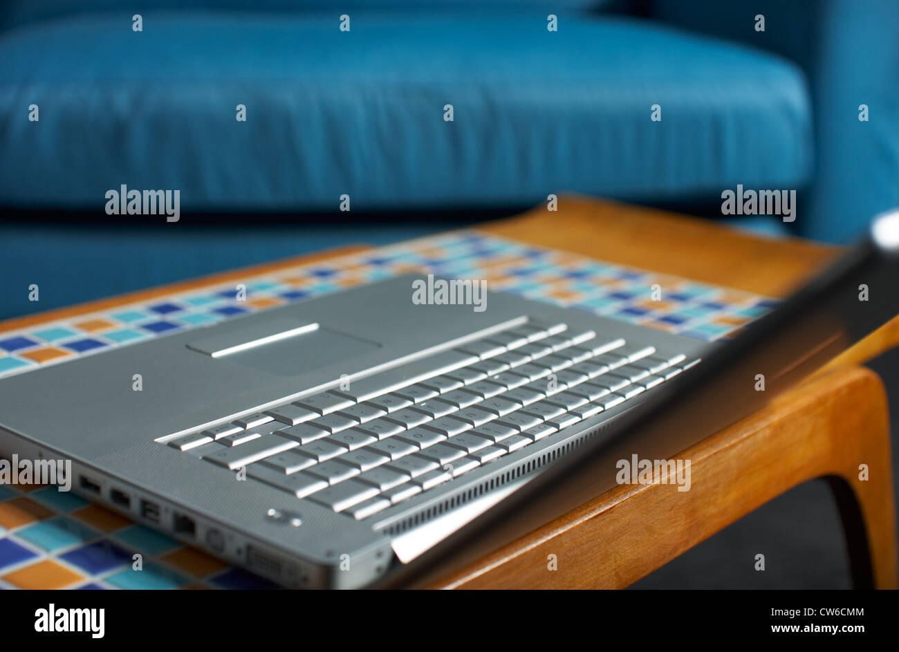 An opened laptop on a side table Stock Photo - Alamy