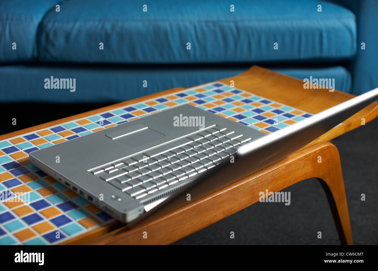 An opened laptop on a side table Stock Photo - Alamy