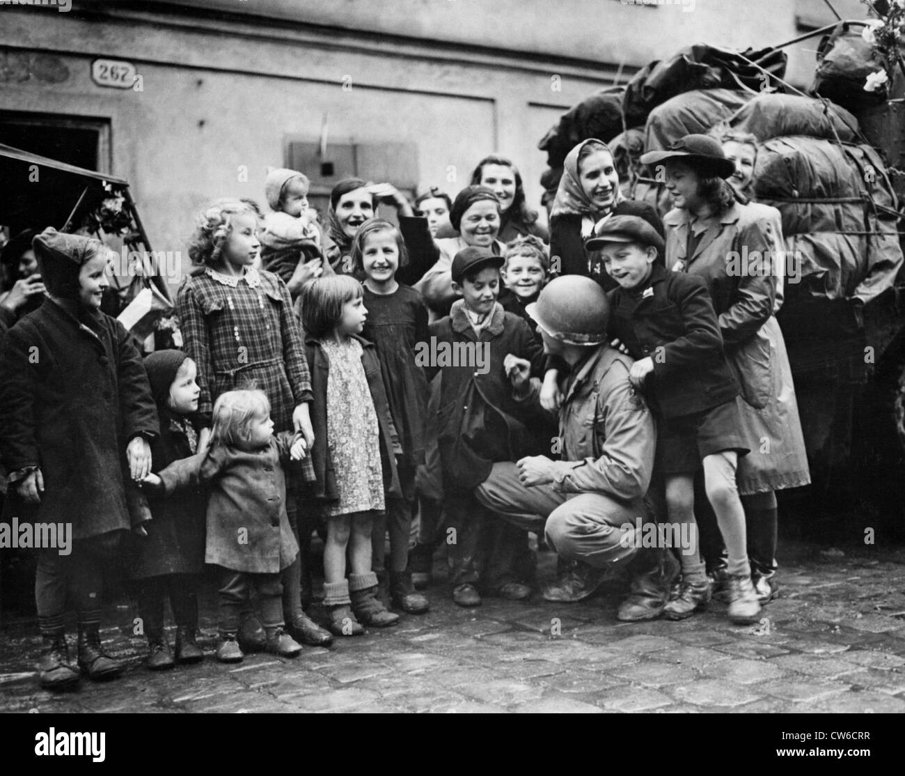 Children surround him Black and White Stock Photos & Images - Alamy