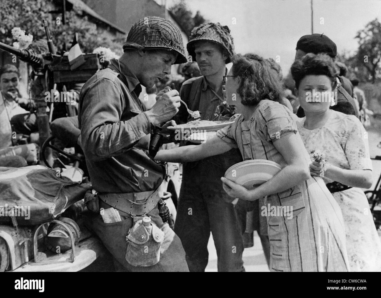 U.S. troops sample Breton cooking near Champigne (France) summer 1944 ...