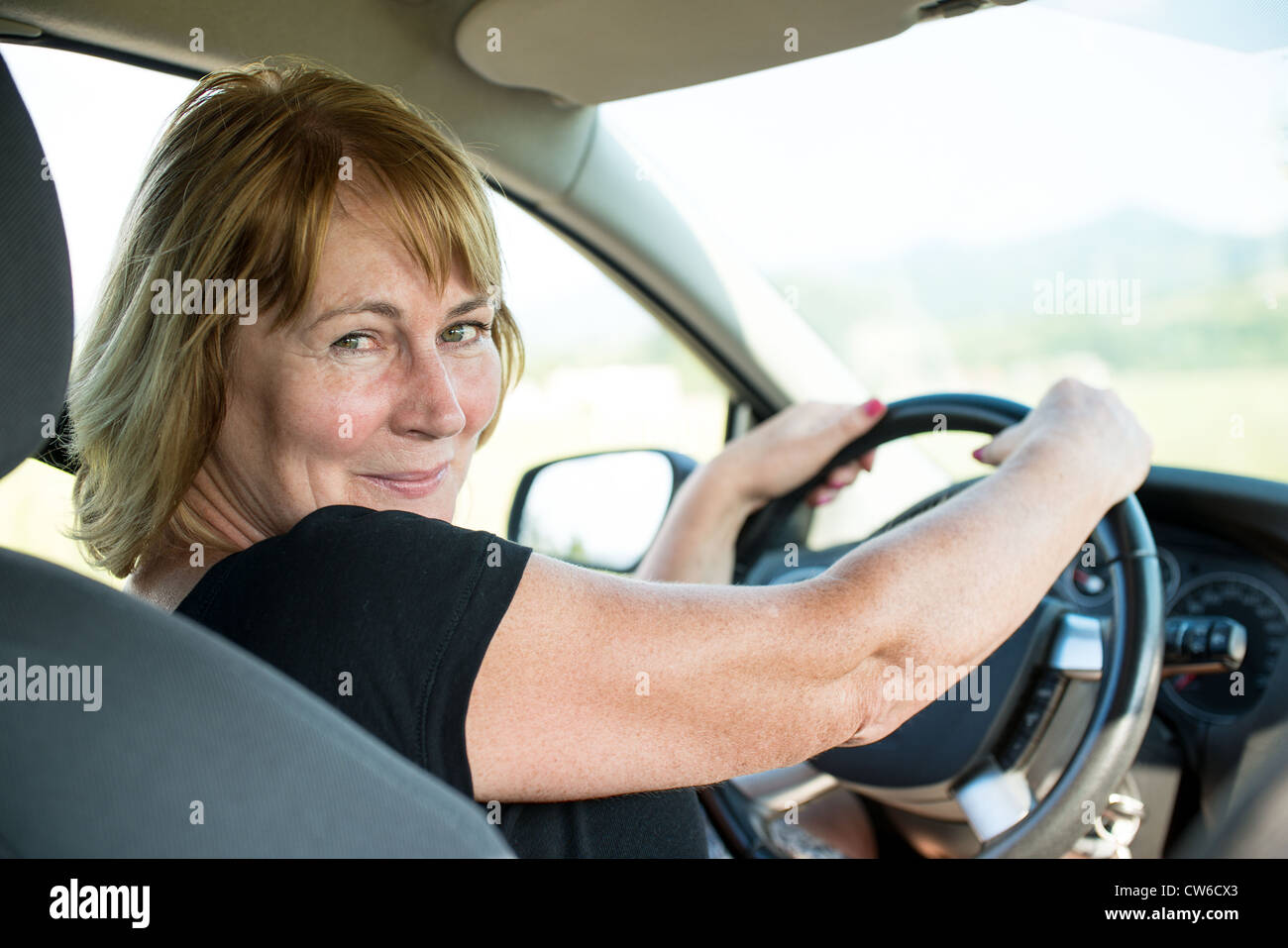 Lifestyle photo of attractive senior woman driving car Stock Photo - Alamy