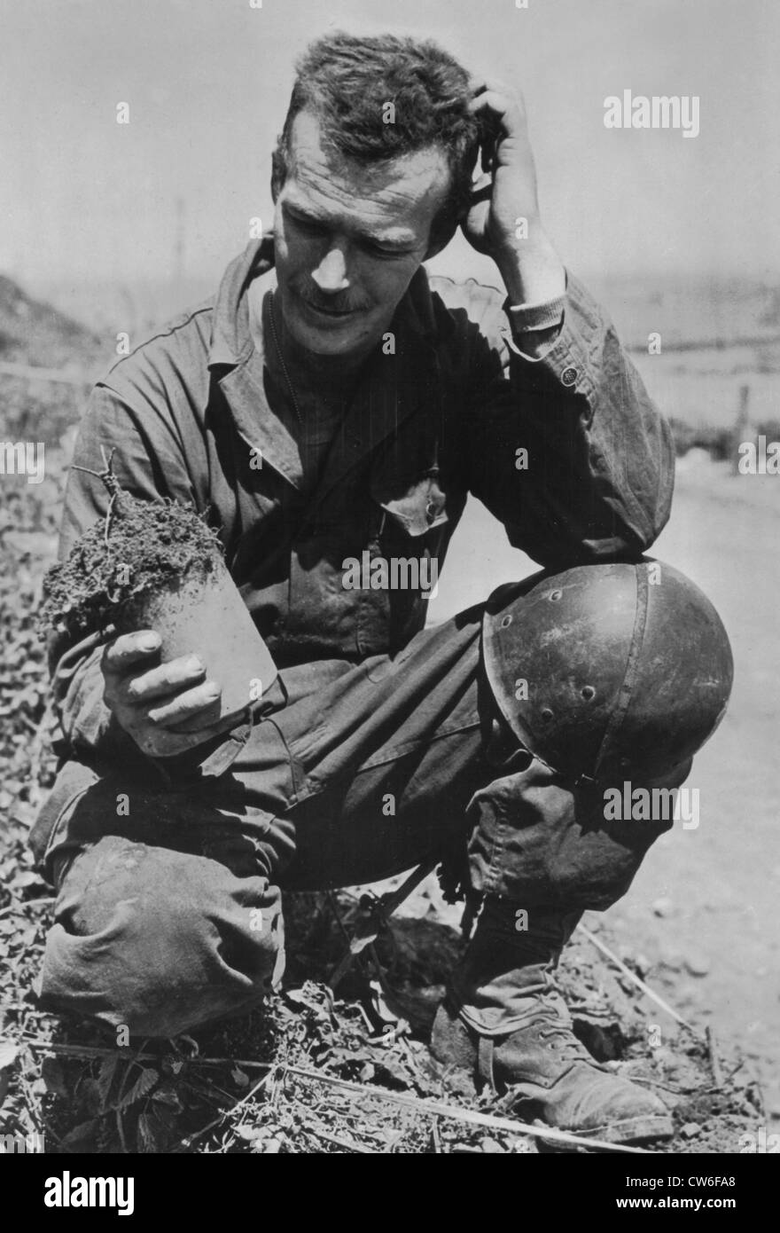 American soldier examines a German mine in Normandy, July 1944 Stock ...