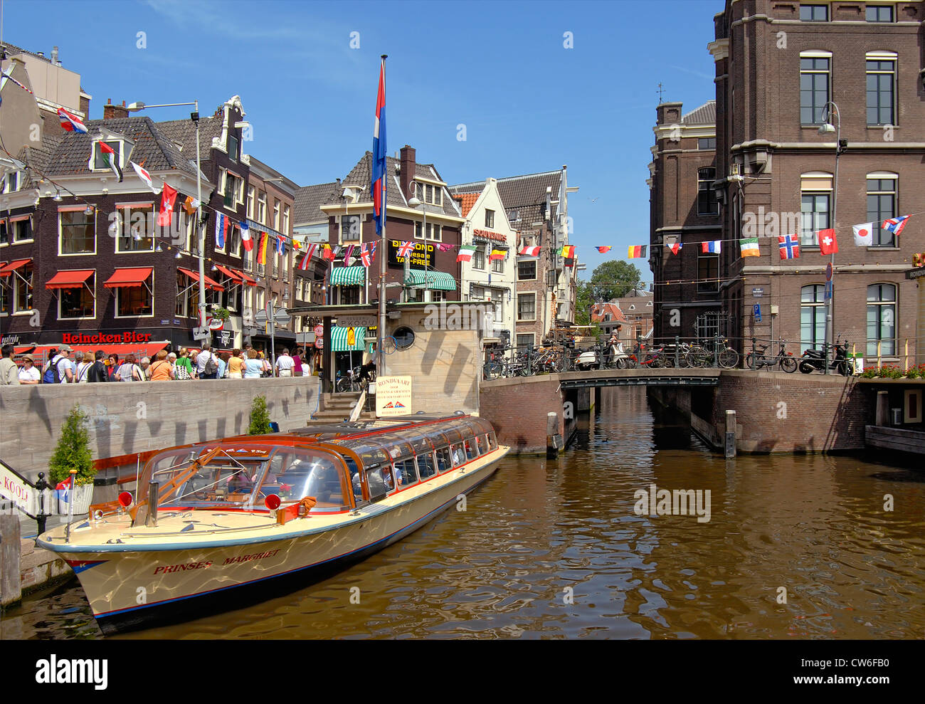 typical sightseeing boat in a water channel in Amsterdam, Netherlands ...