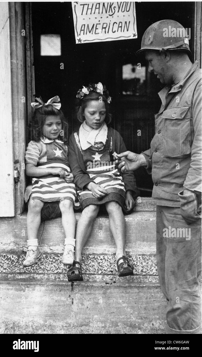 A GI's giving candies to two French girls in Normandy (1944 Stock Photo ...