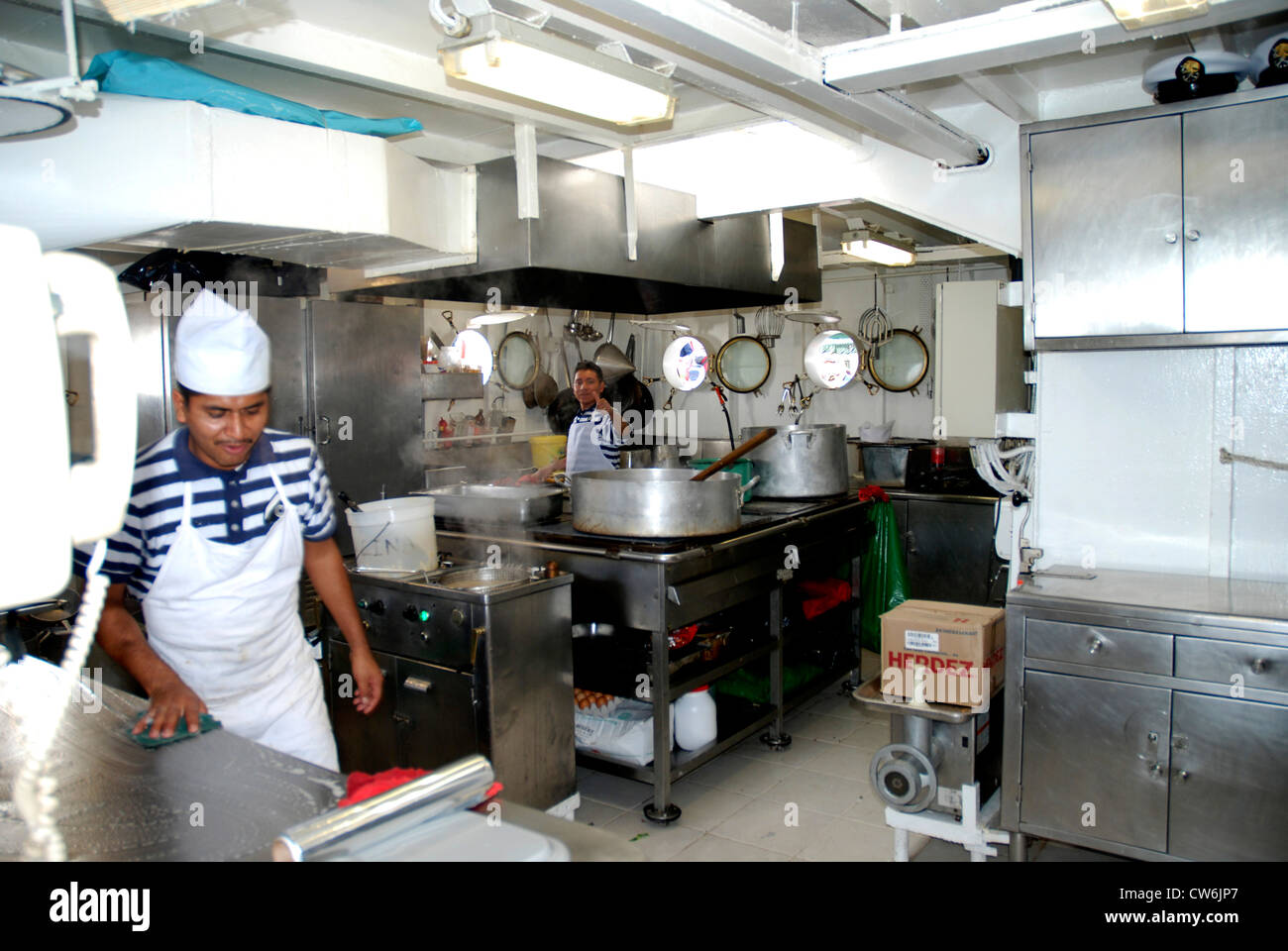 Galley Kitchen Of Container Ship With Crew Chef Smiling