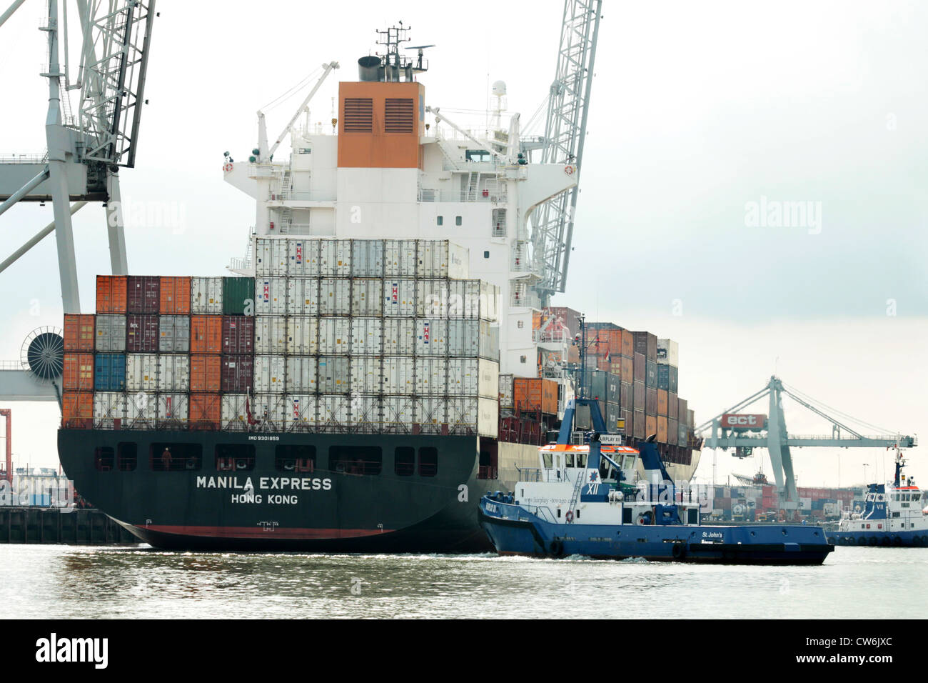 laden containership with tug in Port of Rotterdam Stock Photo - Alamy